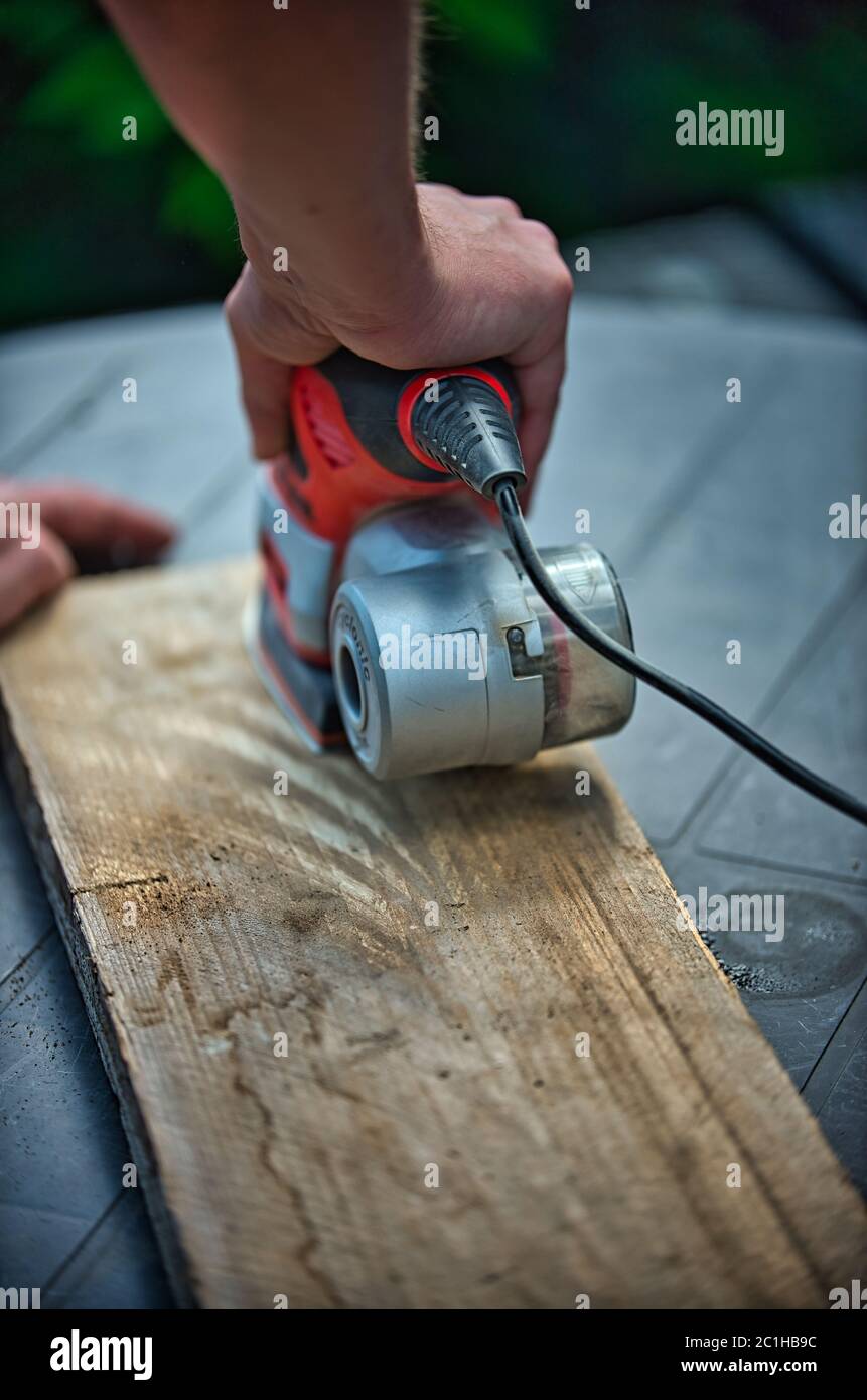 Hand wooden board is processed with a grinding machine Stock Photo - Alamy