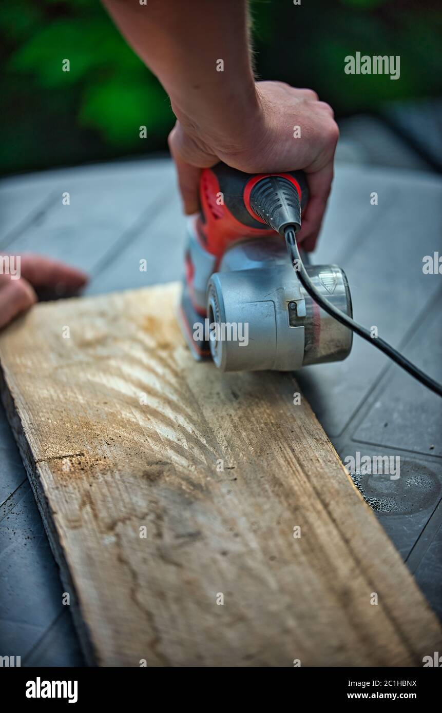 Hand wooden board is processed with a grinding machine Stock Photo - Alamy