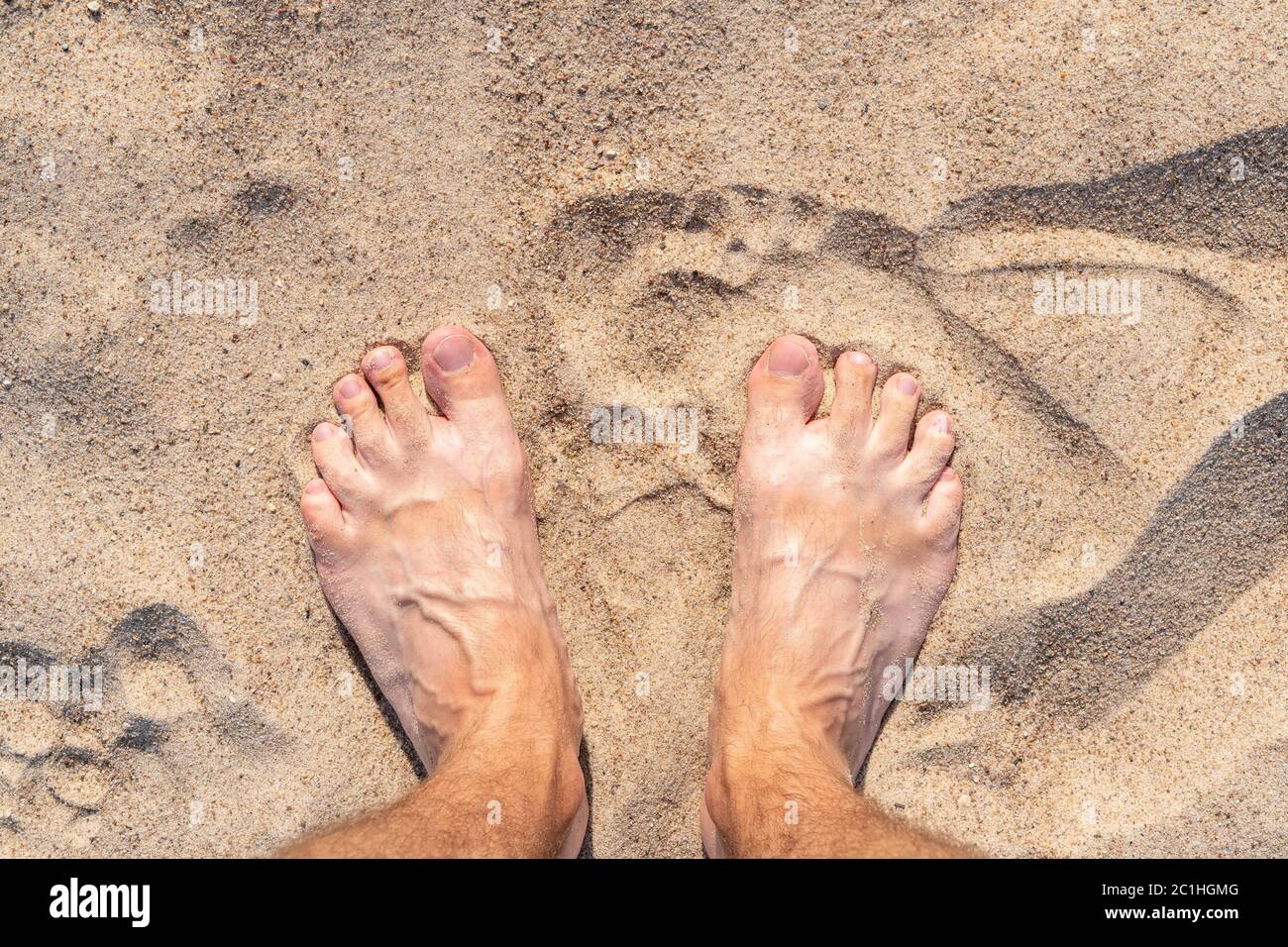 Feet on beach sand background Stock Photo - Alamy