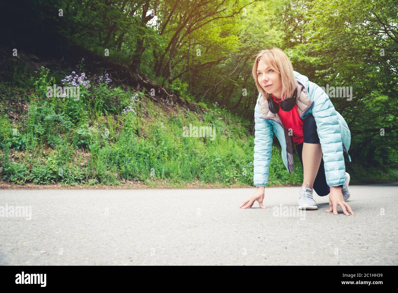 Athletic woman running in countryside road. Fitness female runner in ...