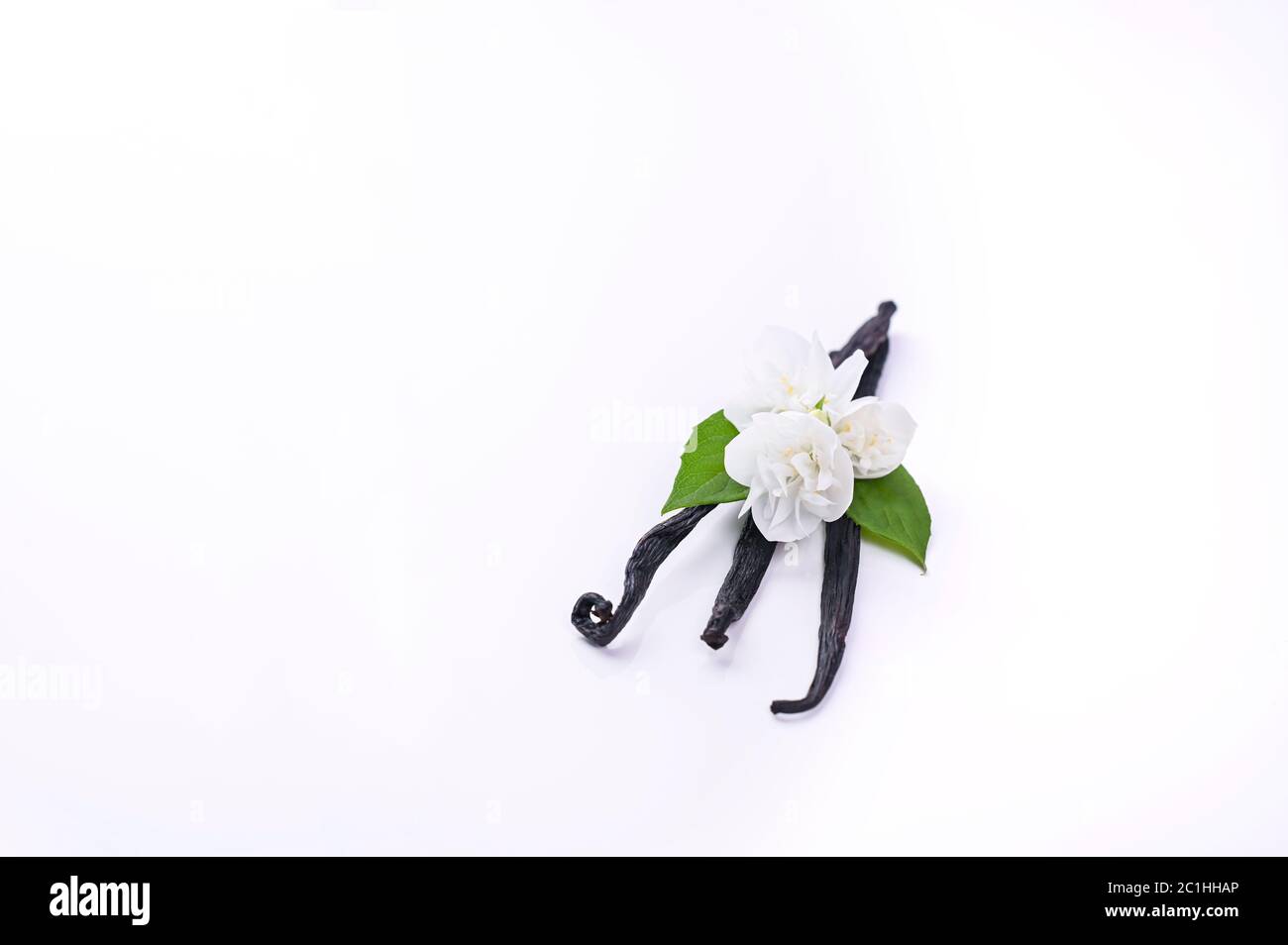 Sweet Vanilla sticks with flowers on white backgrounds.The ingredients ...