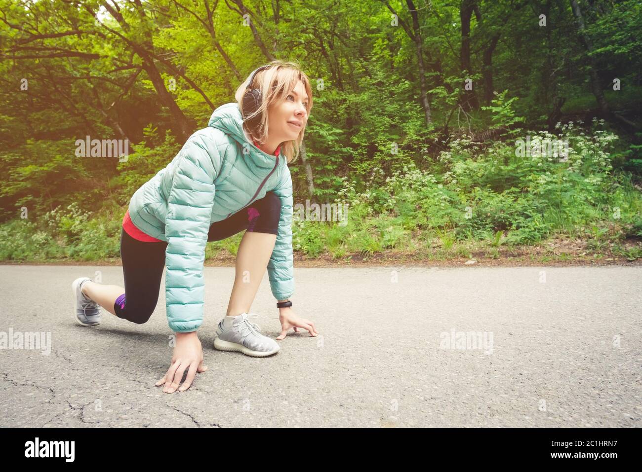 Athletic woman running in countryside road. Fitness female runner in ...