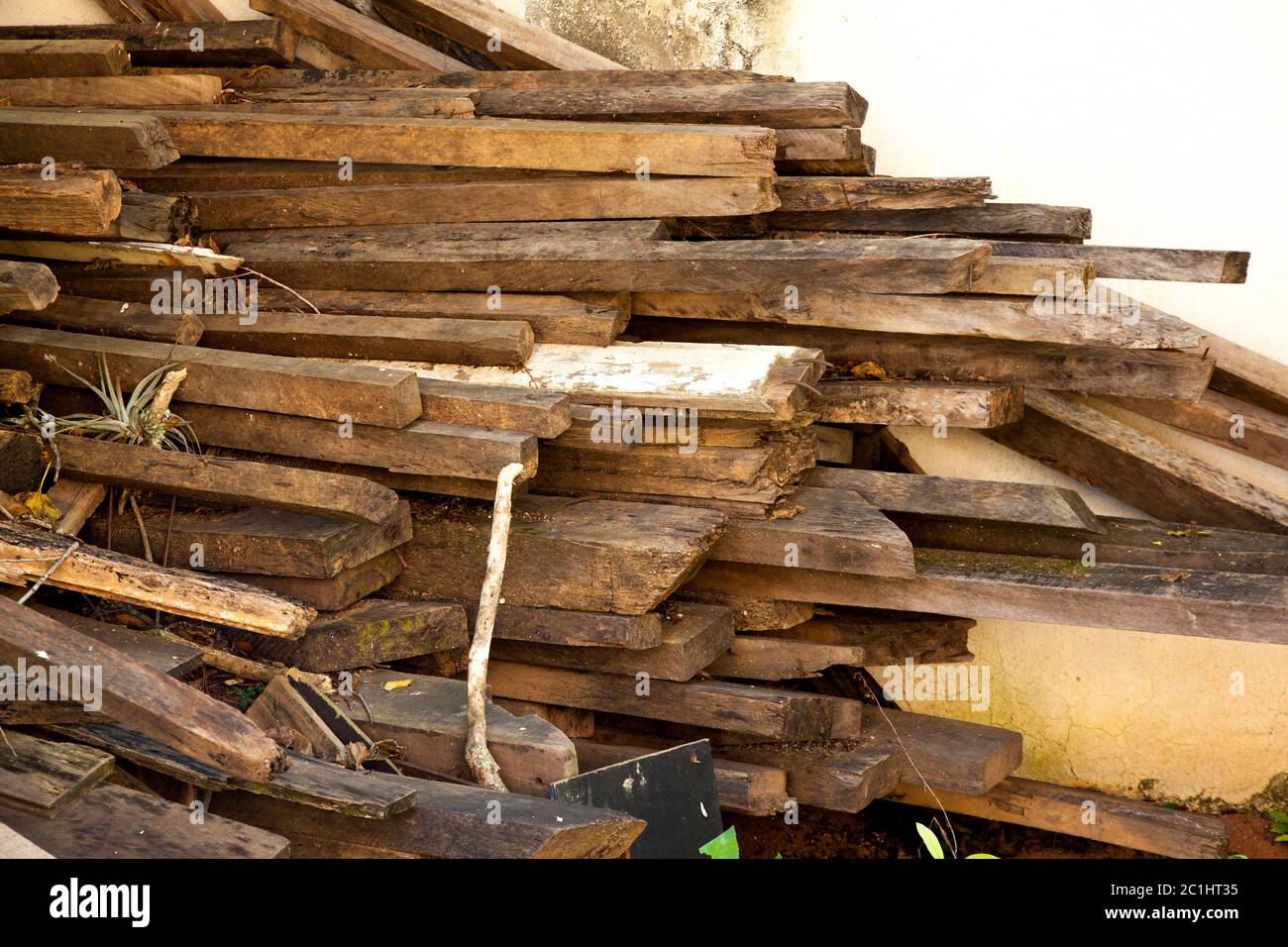 Old wood beam pile - construction material - recycle Stock Photo - Alamy