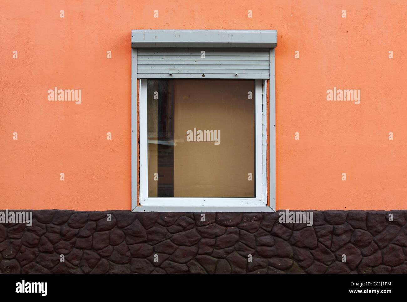 One window in the house is half closed by external shutters. bright ...