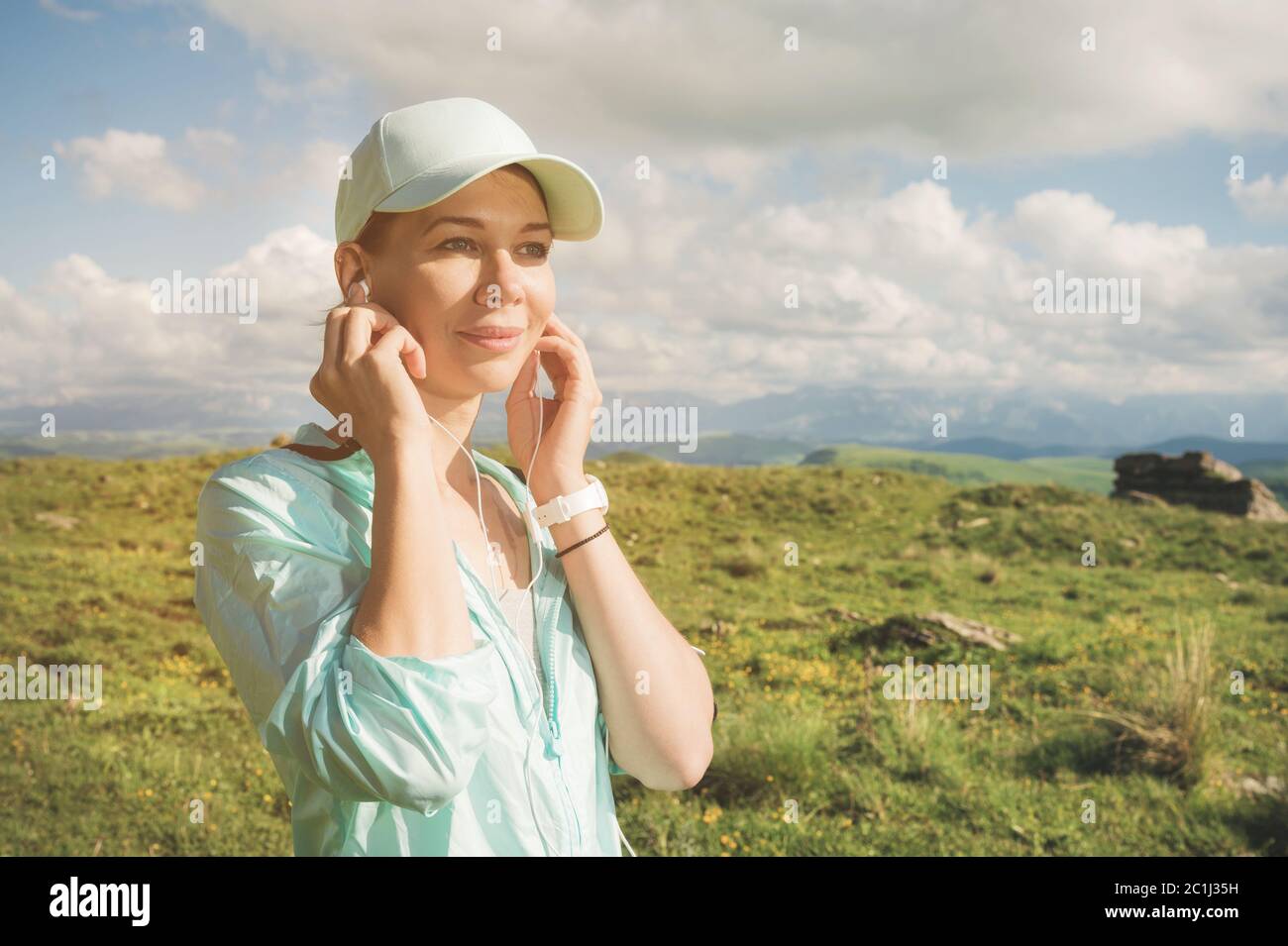 Fitness runner woman listening to music on the nature. Portrait of ...