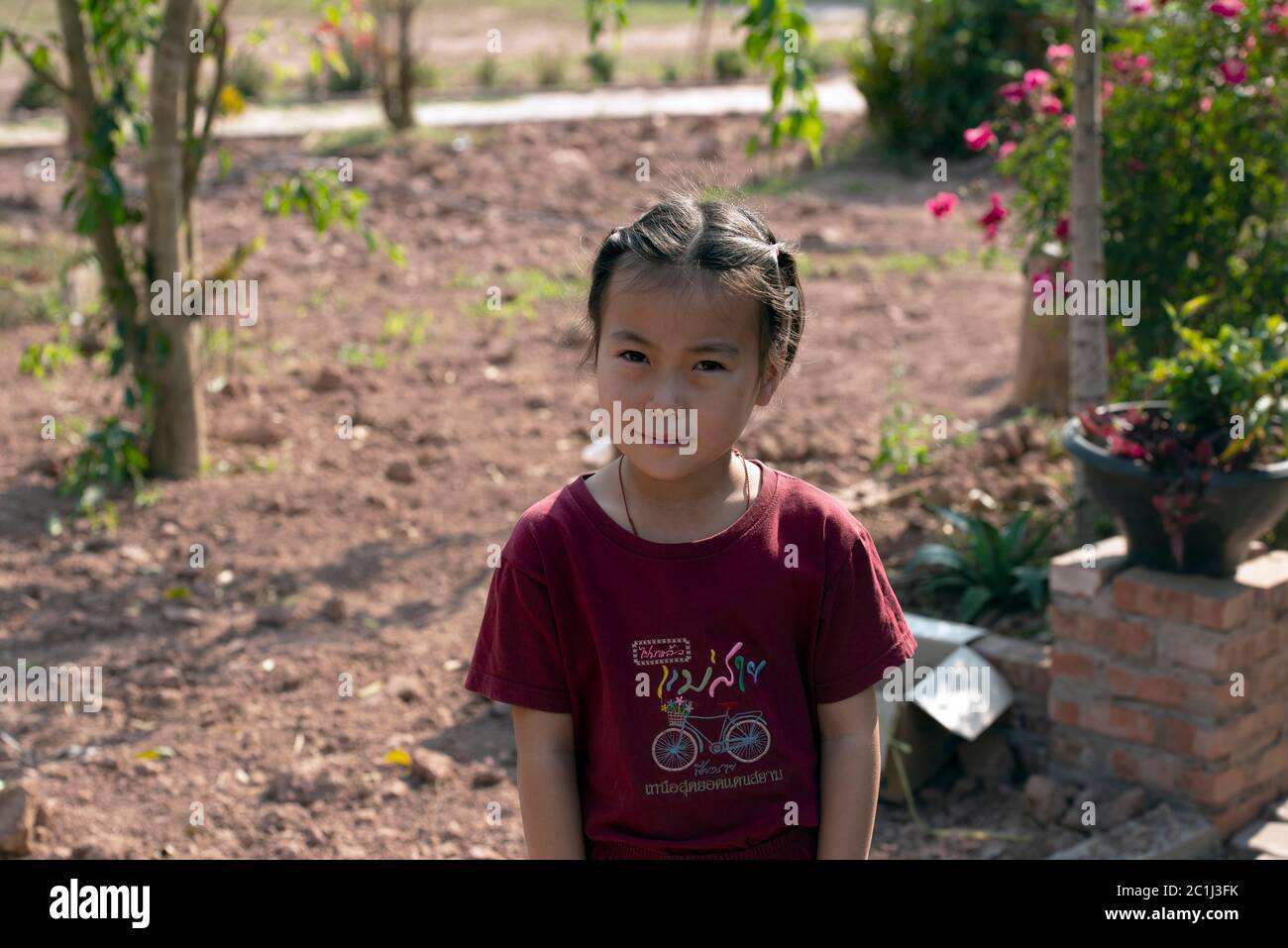 A young, indigenous, ethnic Tai Deng girl in her village in Luang ...