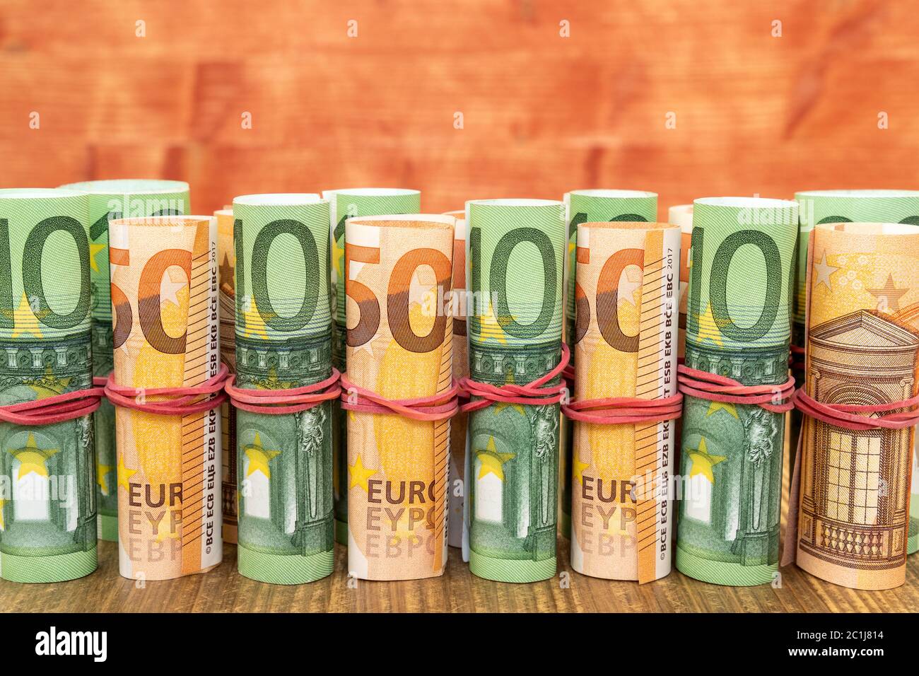 Euro banknote rolls in one row Stock Photo - Alamy