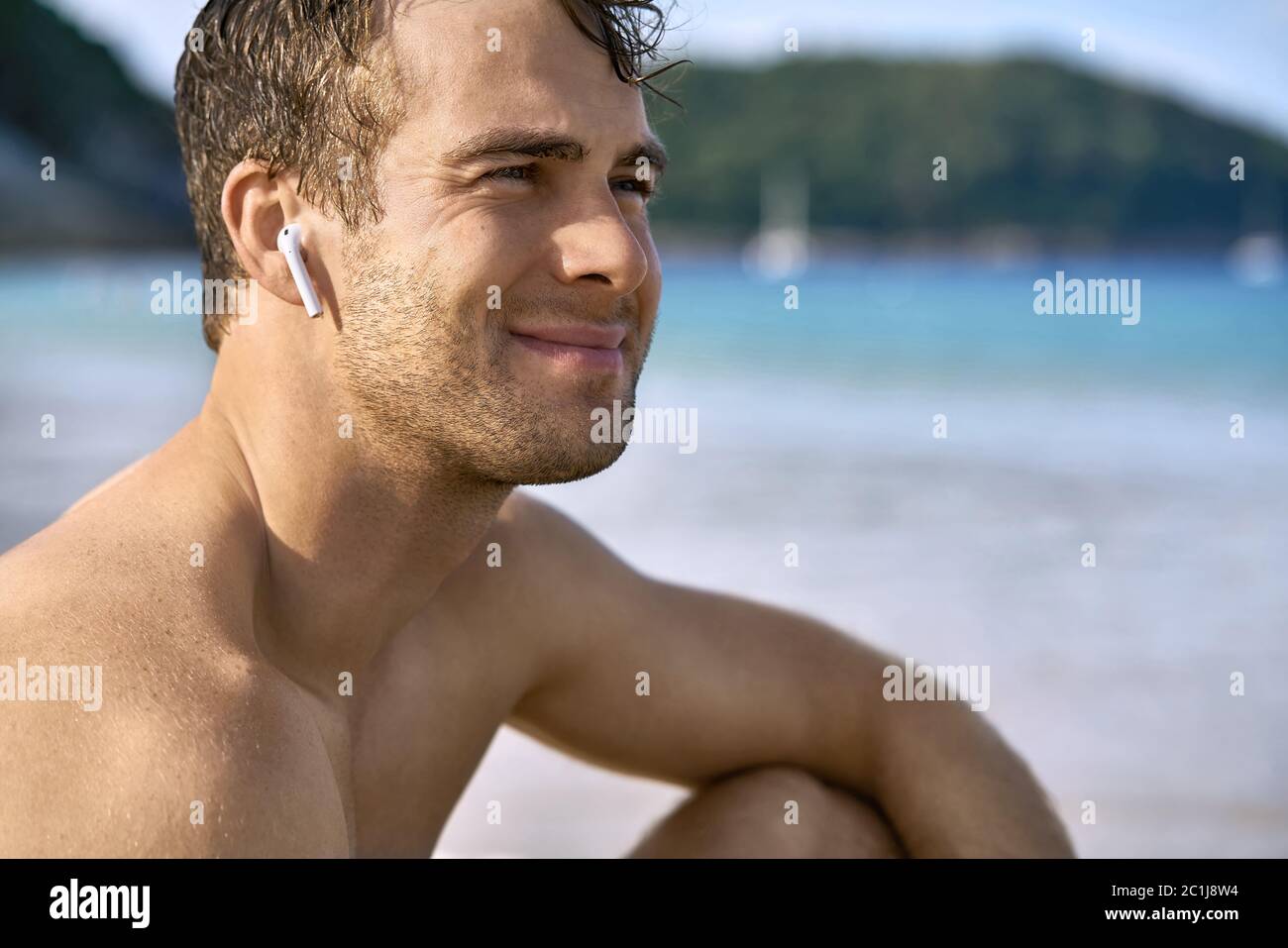 Tanned guy on beach Stock Photo - Alamy