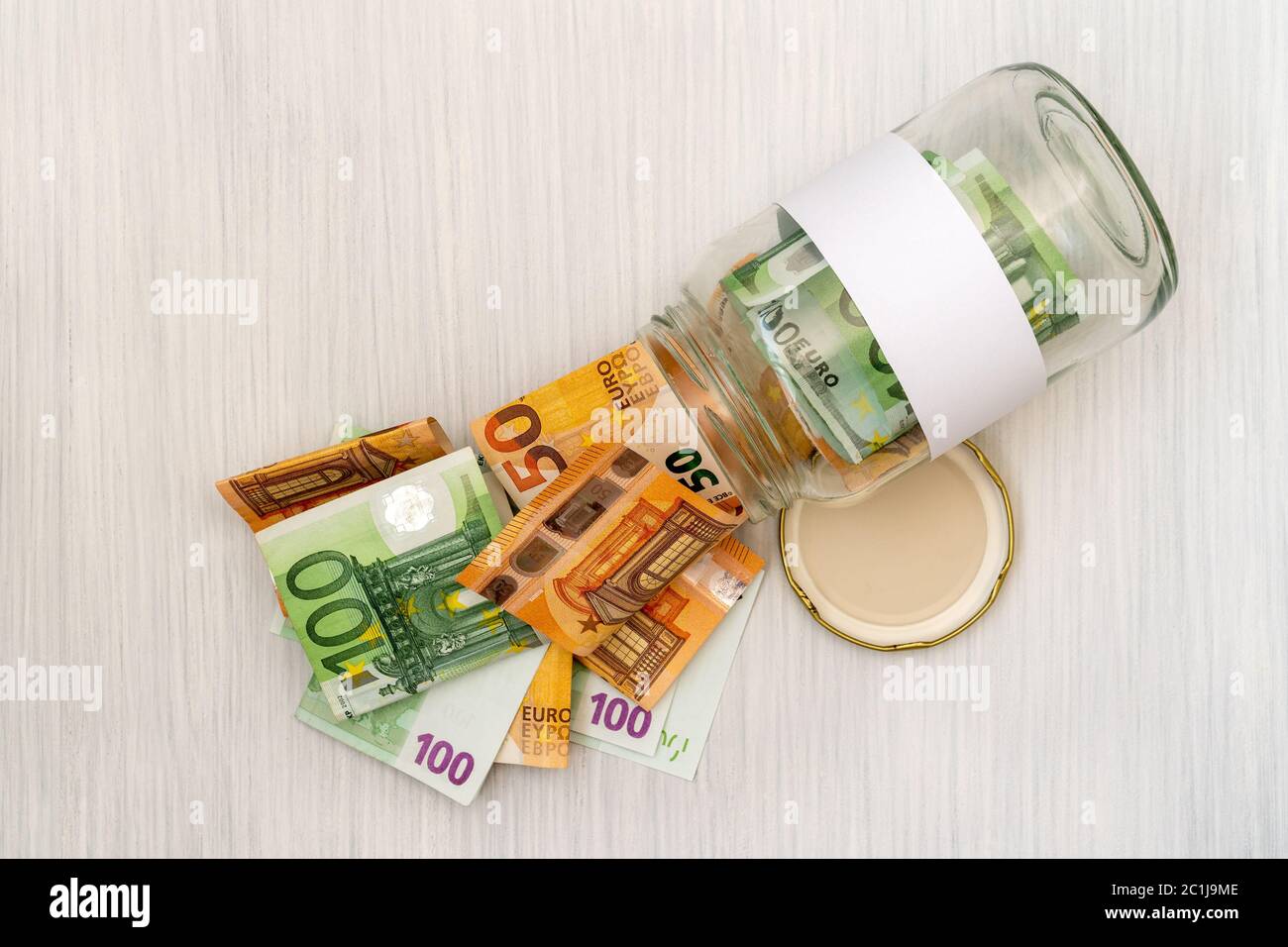 Money jar with blank label Stock Photo - Alamy