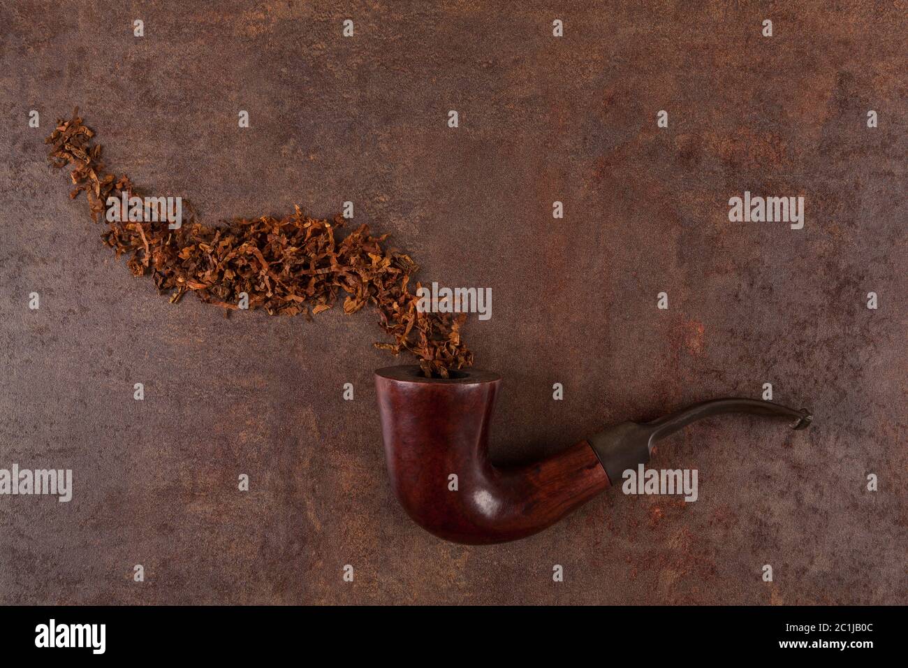 Old smoking pipe and tobacco on a vintage background. Above Stock Photo ...
