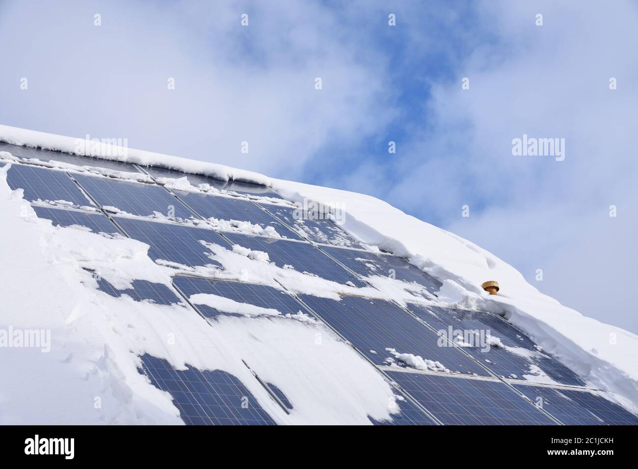 Snow-covered solar system on a house in winter Stock Photo - Alamy