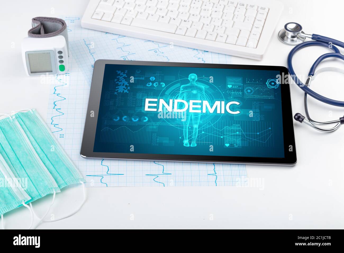 Tablet pc and doctor tools with ENDEMIC inscription, coronavirus ...