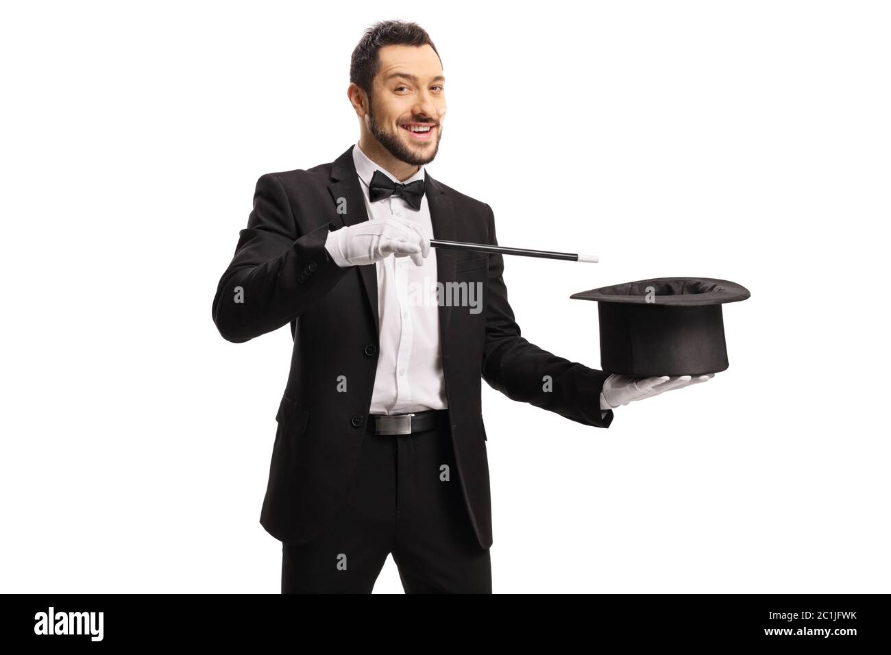 Magician performing a hat-trick with a magic wand isolated on white ...