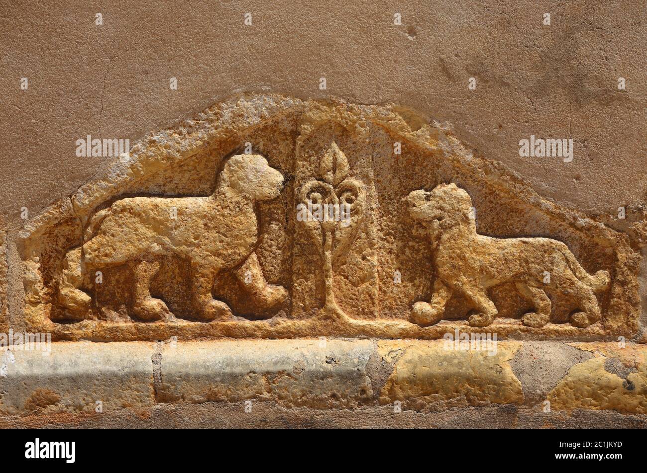 Lions and a fleur de lis sculpted on the wall of a medieval church ...