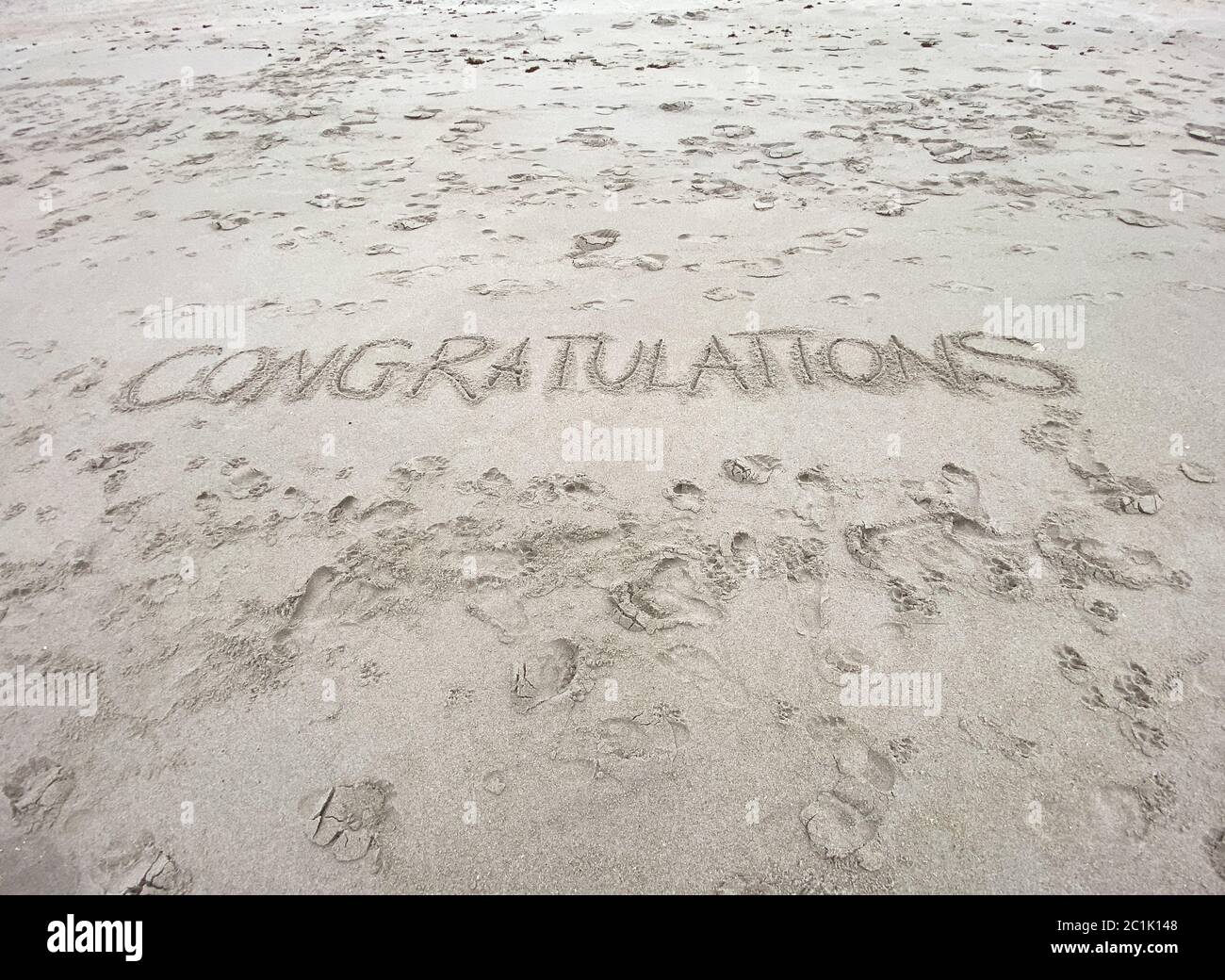 Congratulations written in the sand on a beach Stock Photo - Alamy