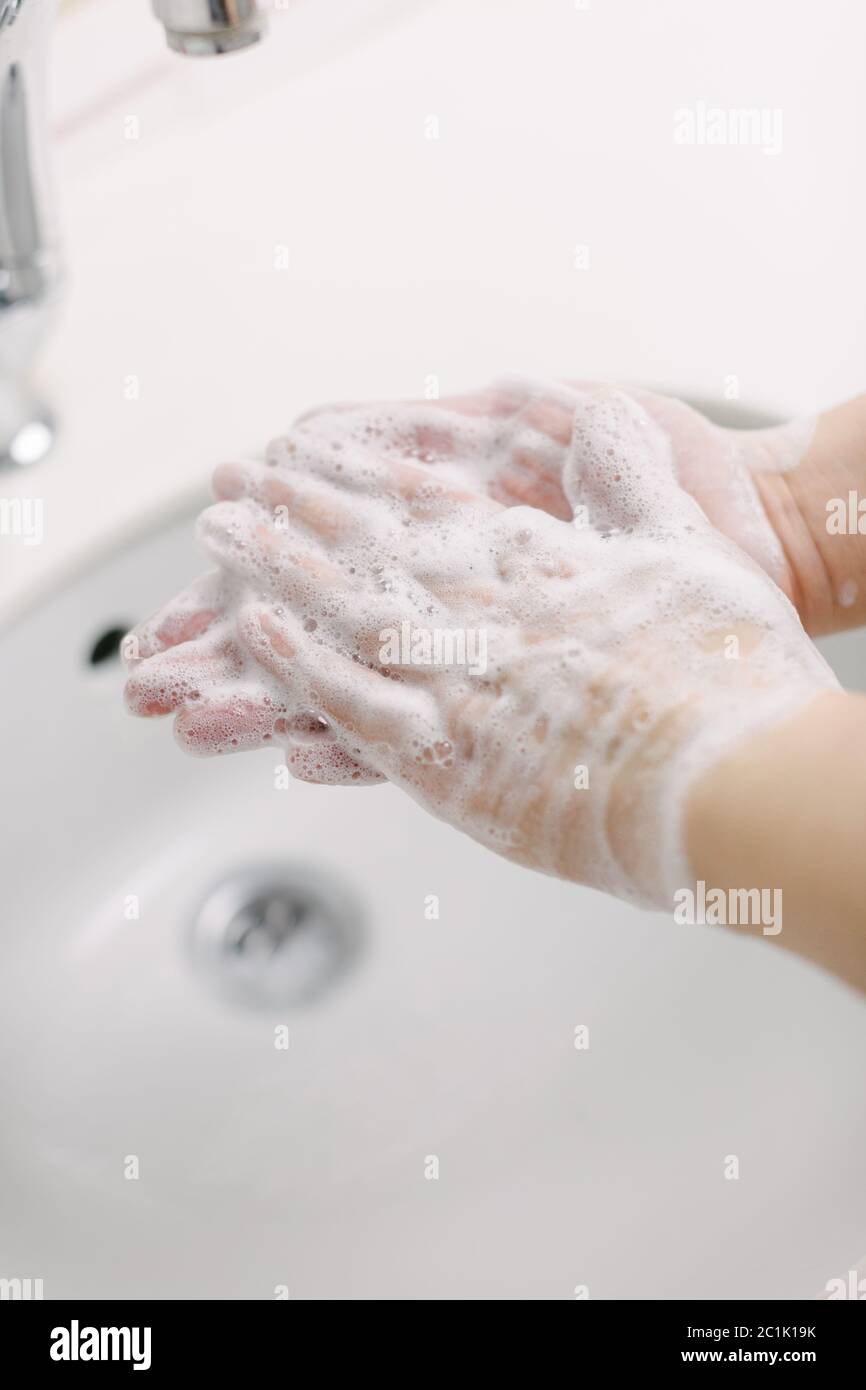 Woman washes her hands by surgical hand washing method Stock Photo - Alamy