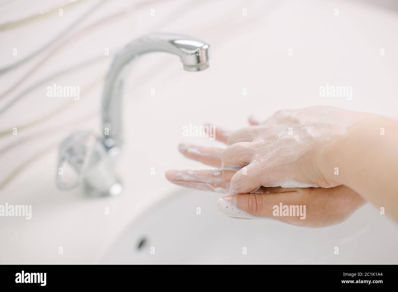 Woman washes her hands by surgical hand washing method Stock Photo - Alamy