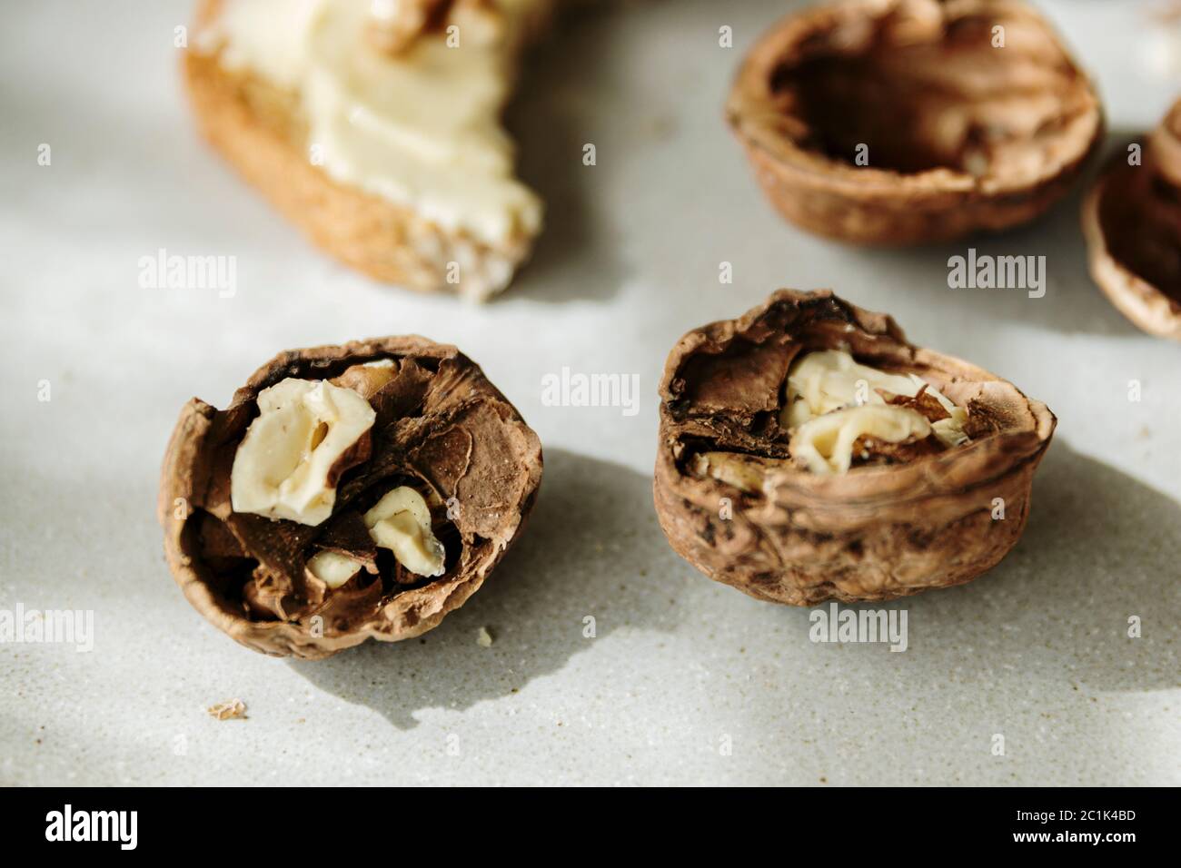 Nuts split in half on a ceramic grey plate for breakfast Stock Photo ...