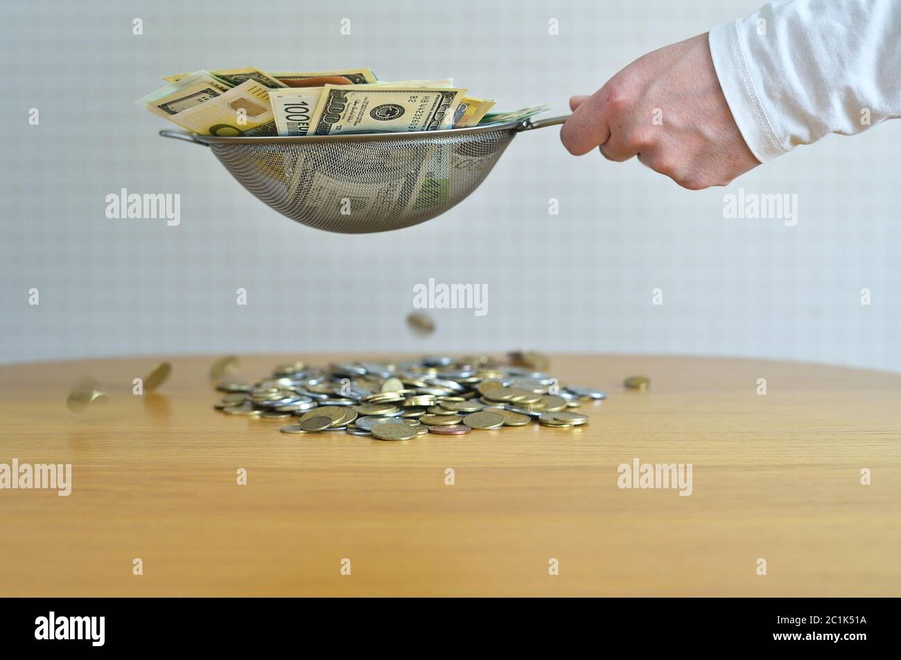 Coins falling through hand hi-res stock photography and images - Alamy