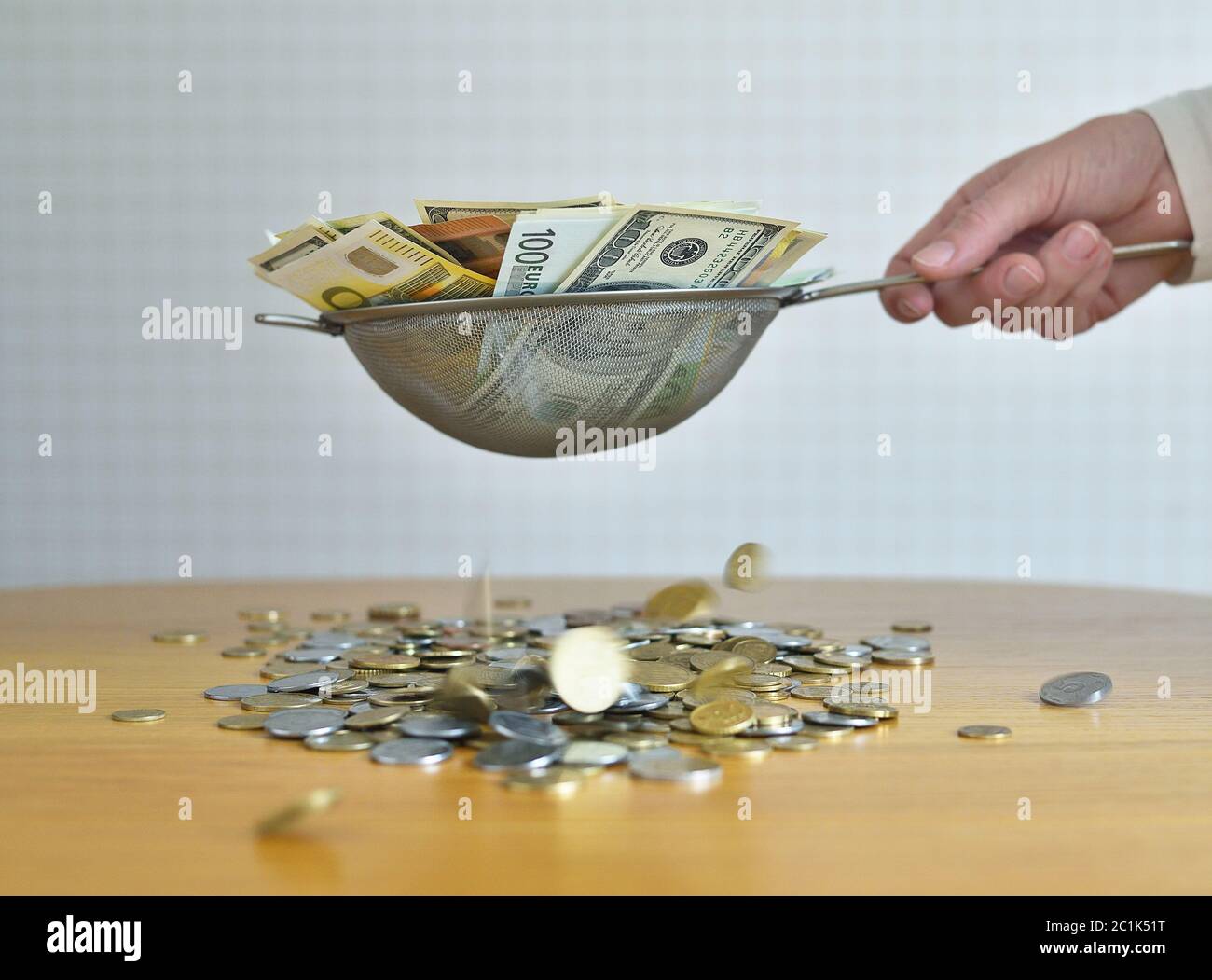 Coins falling through hand hi-res stock photography and images - Alamy