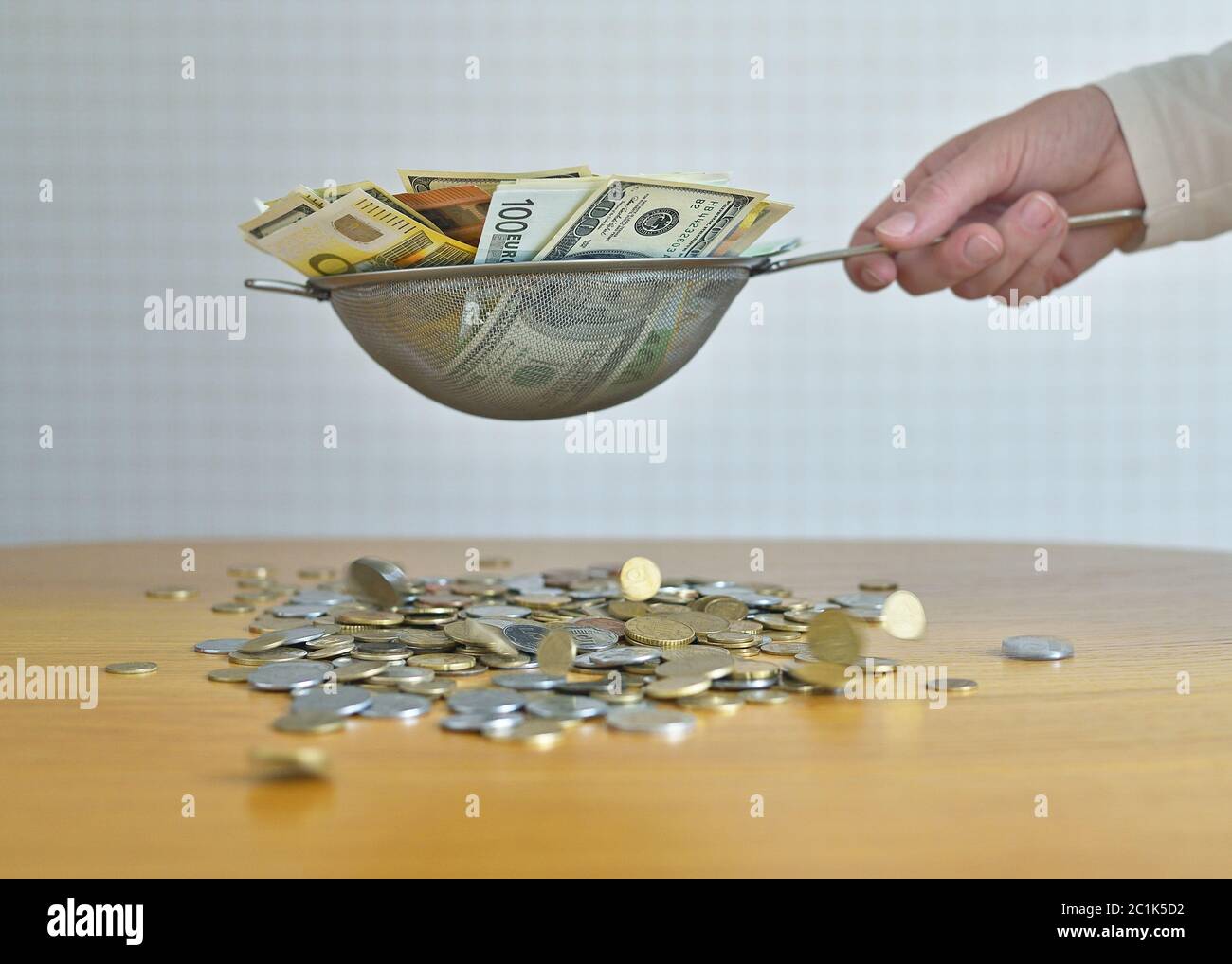 Coins falling through hand hi-res stock photography and images - Alamy