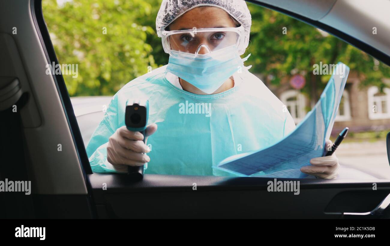 Doctor woman use infrared thermometer gun to check body temperature ...