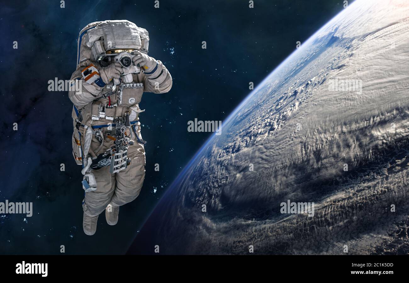 Astronaut in orbit of the planet Earth. Solar system Science fiction ...