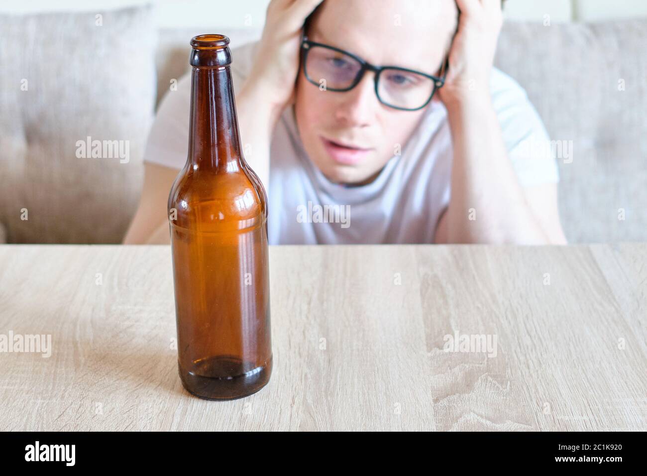A man got drunk after drinking beer from a bottle Stock Photo - Alamy