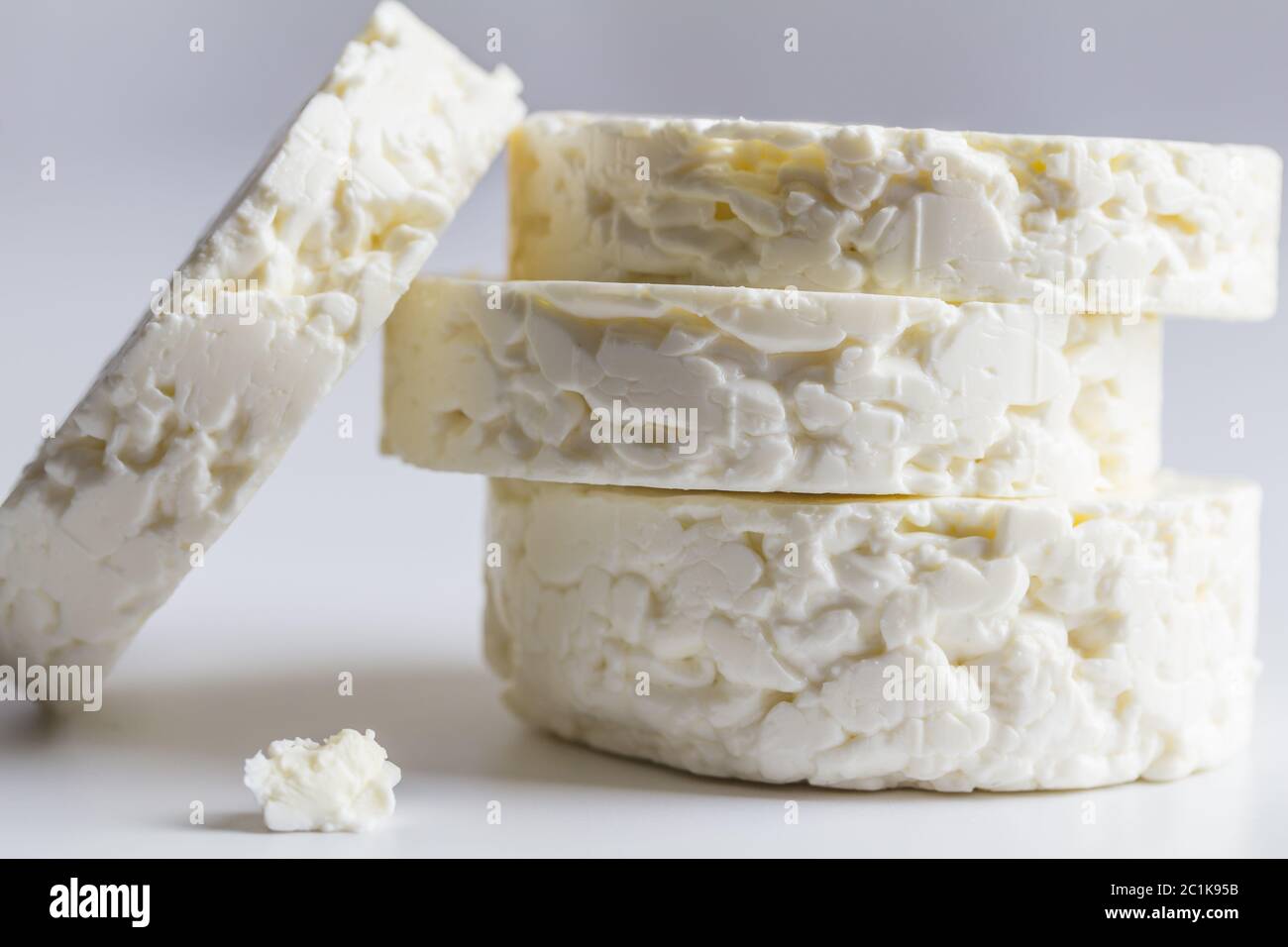 Feta cheese disk stack on white background Stock Photo - Alamy