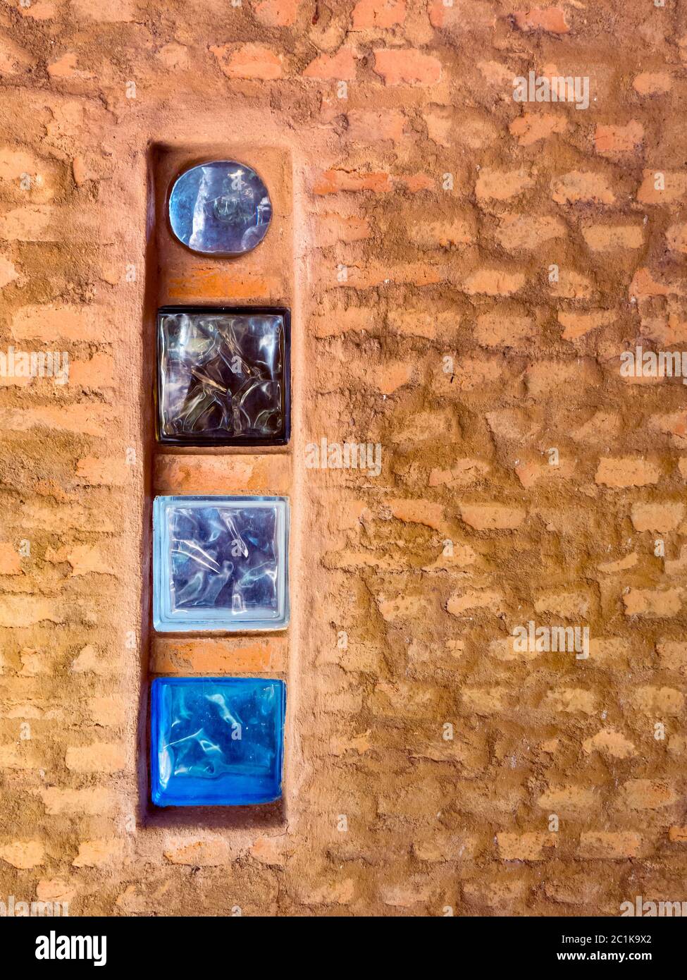 Brick wall with colored glass brick as windows in a rustic house Stock ...