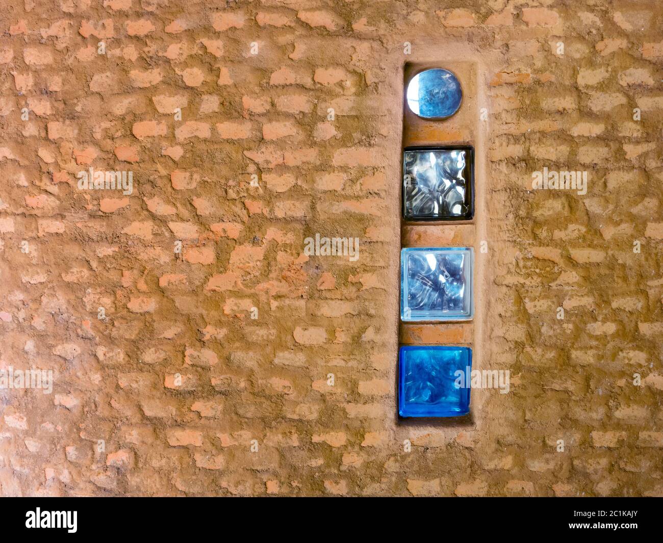 Brick wall with colored glass brick as windows in a rustic house Stock ...