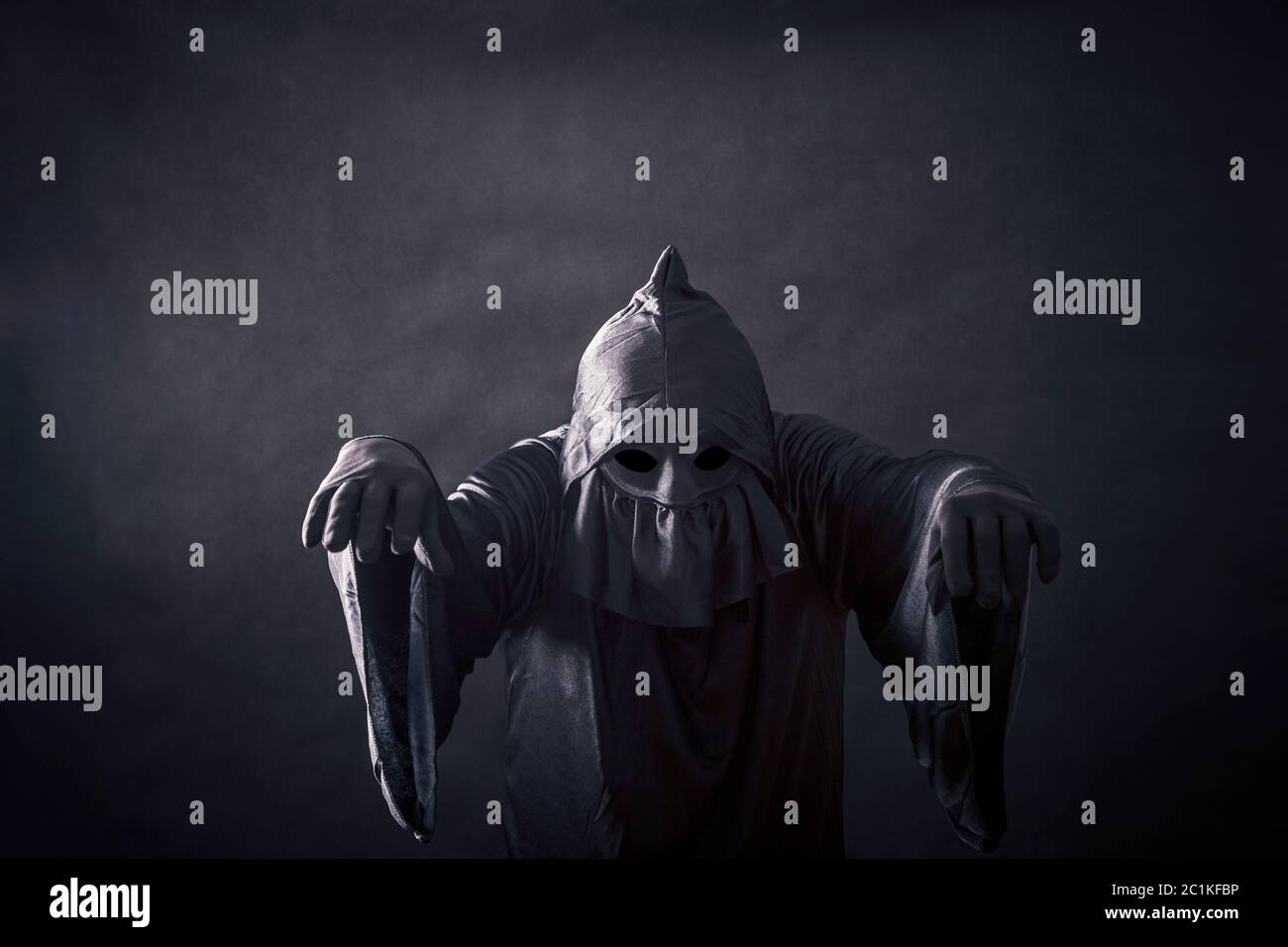 Scary figure in hooded cloak Stock Photo - Alamy