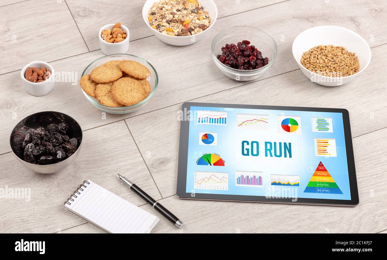 Organic food and tablet pc showing GO RUN inscription, healthy ...