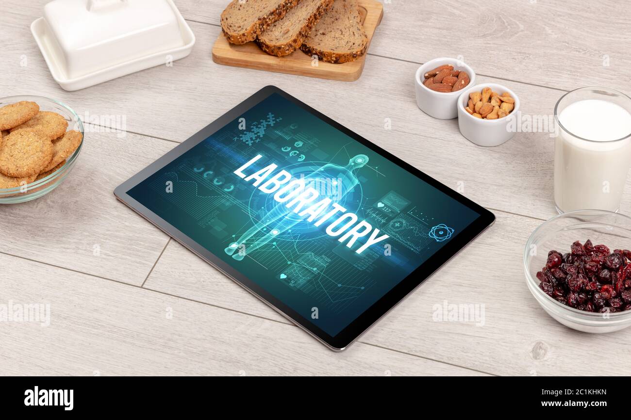 LABORATORY concept in tablet with fruits, top view Stock Photo - Alamy