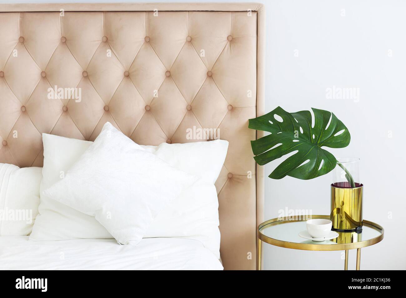 Modern bedroom with table side and pillows and coffee Stock Photo - Alamy