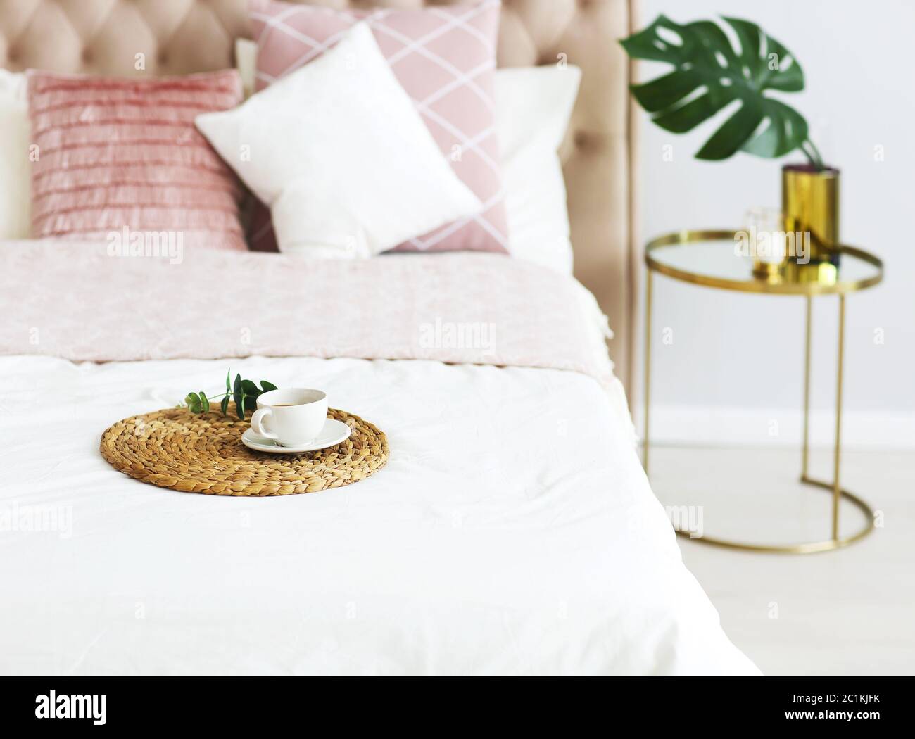 Modern bedroom with table side and pillows on the bed Stock Photo - Alamy