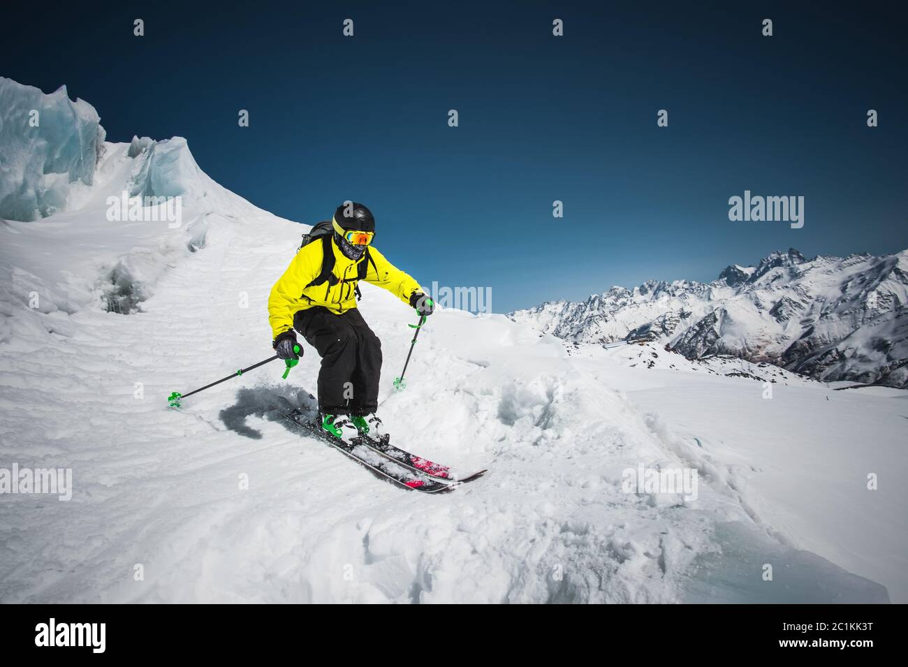 Professional skier at the speed before jumping from the glacier in ...