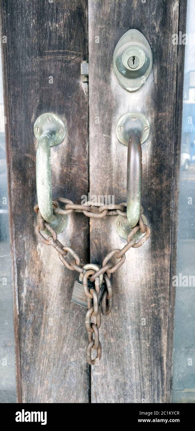 Door handles chained closed with padlock Stock Photo - Alamy