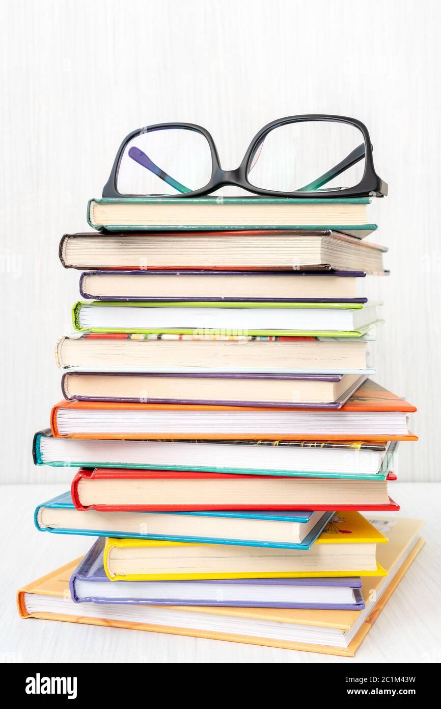 Stack of books with a eyeglasses on top Stock Photo - Alamy
