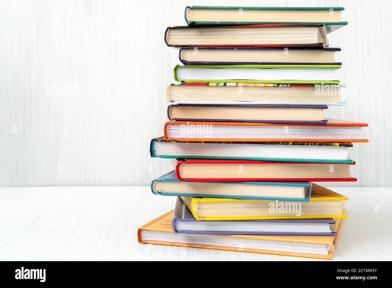 Books stacked on the shelf Stock Photo - Alamy