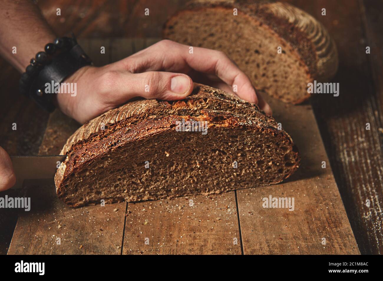 organic bread cut a man's hands Stock Photo - Alamy