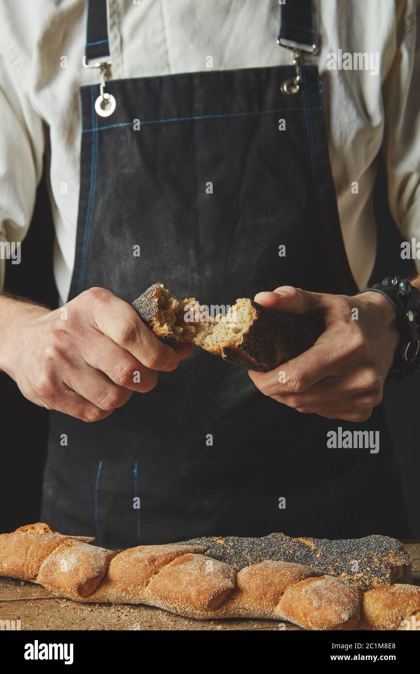Holding a loaf of bread in his hands hi-res stock photography and ...