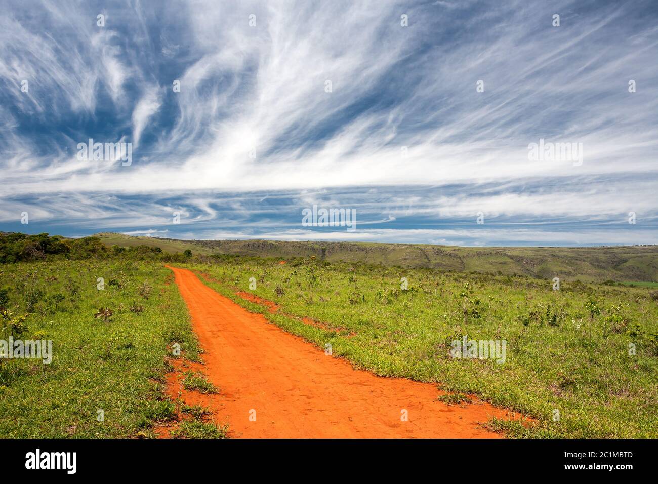 Rural orange dirt road with blue sky and far horizon Stock Photo - Alamy