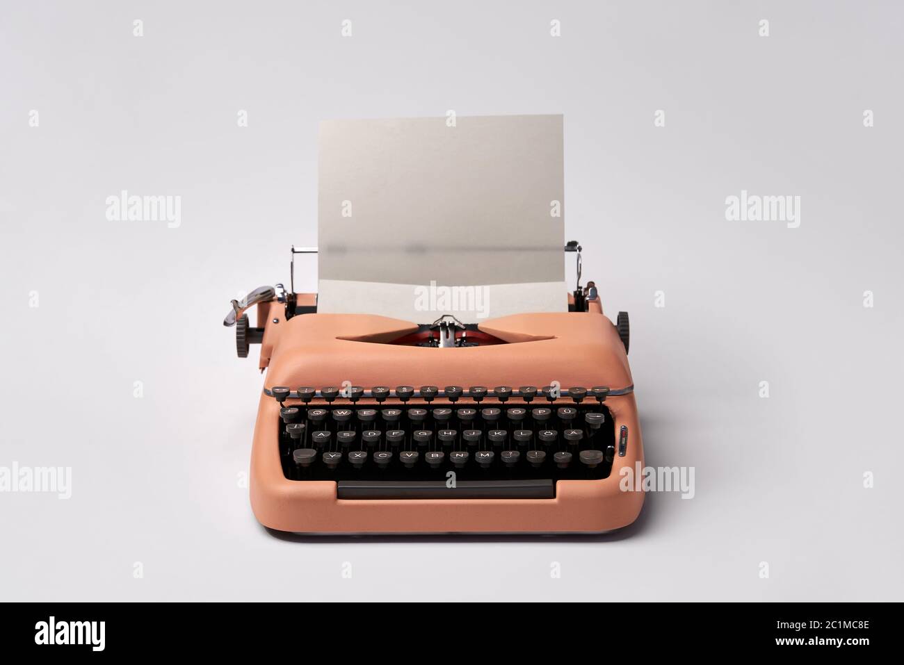 Retro typewriter coral color in studio. Studio shot Stock Photo - Alamy