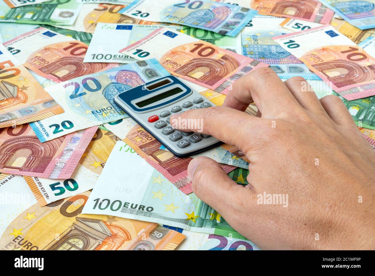 Hand with calculator counts money Stock Photo - Alamy