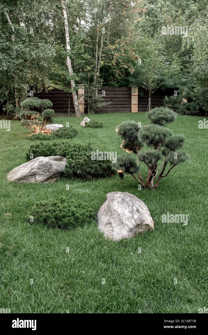 Country house territory with green lawn and fence Stock Photo - Alamy