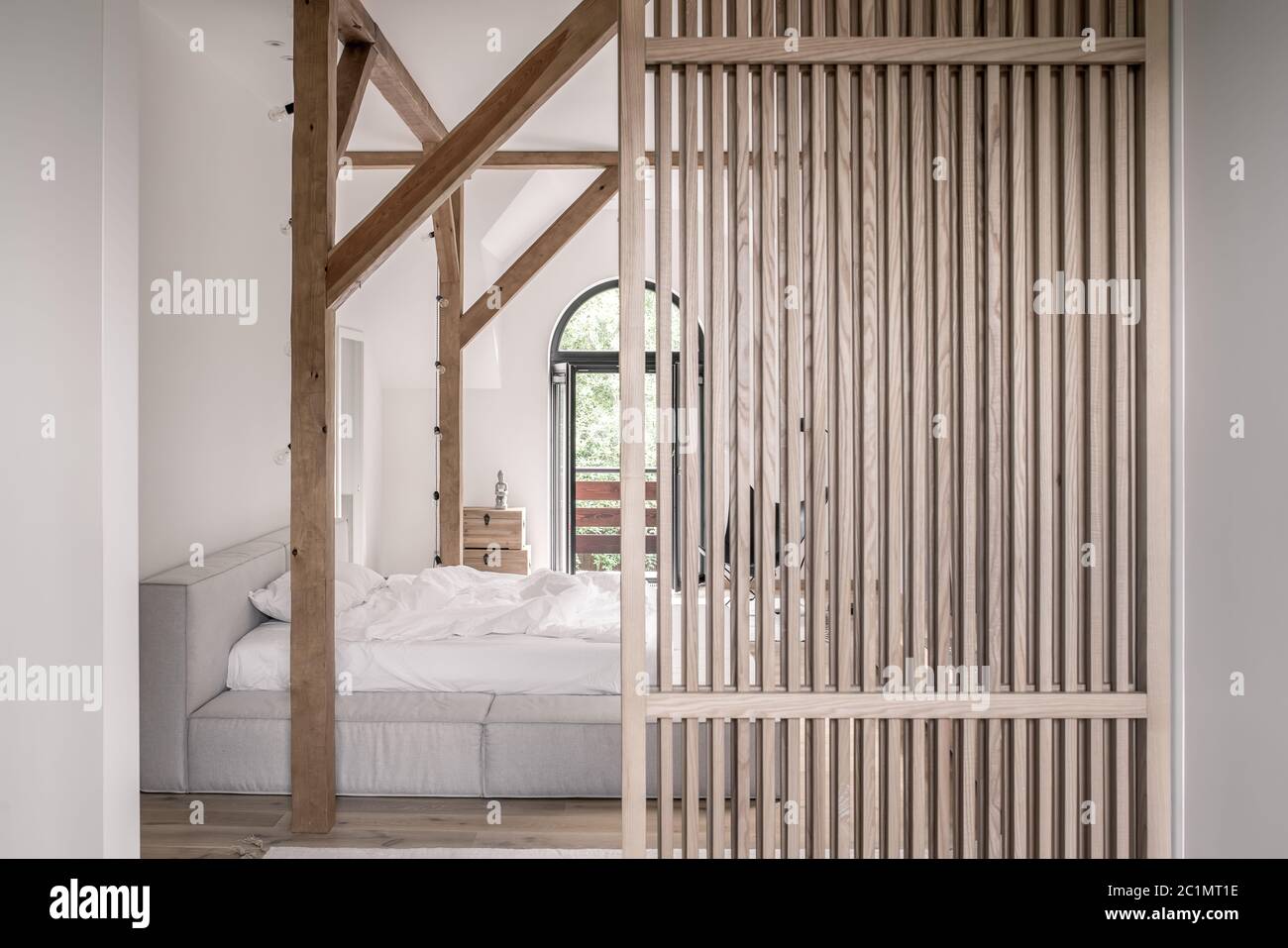 Stylish bedroom in modern style with wooden beams Stock Photo - Alamy