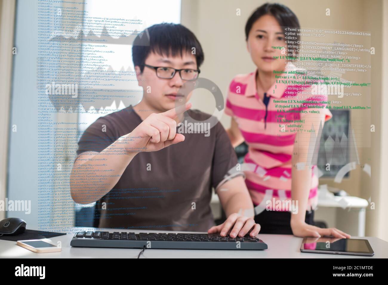 young woman and man working with computer Stock Photo - Alamy