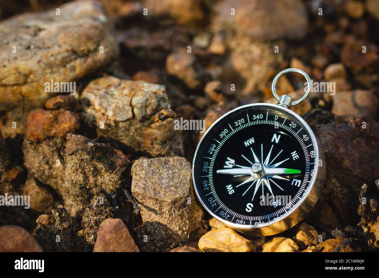 Compass placed on the rock in forest. Closeup and copy space. Concept ...