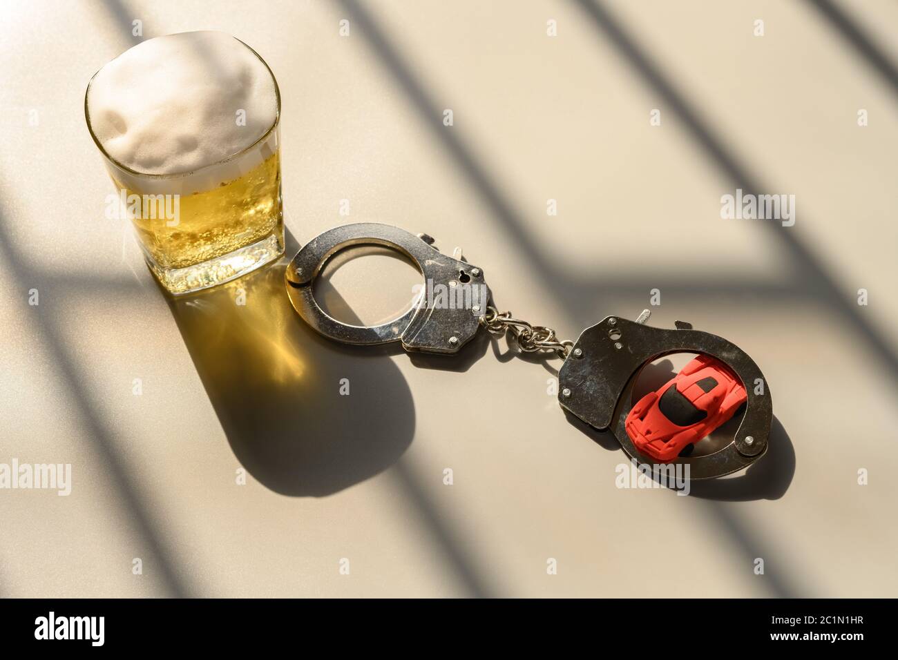 car and handcuffs and cup of beer in jail concept of illegal drunk ...